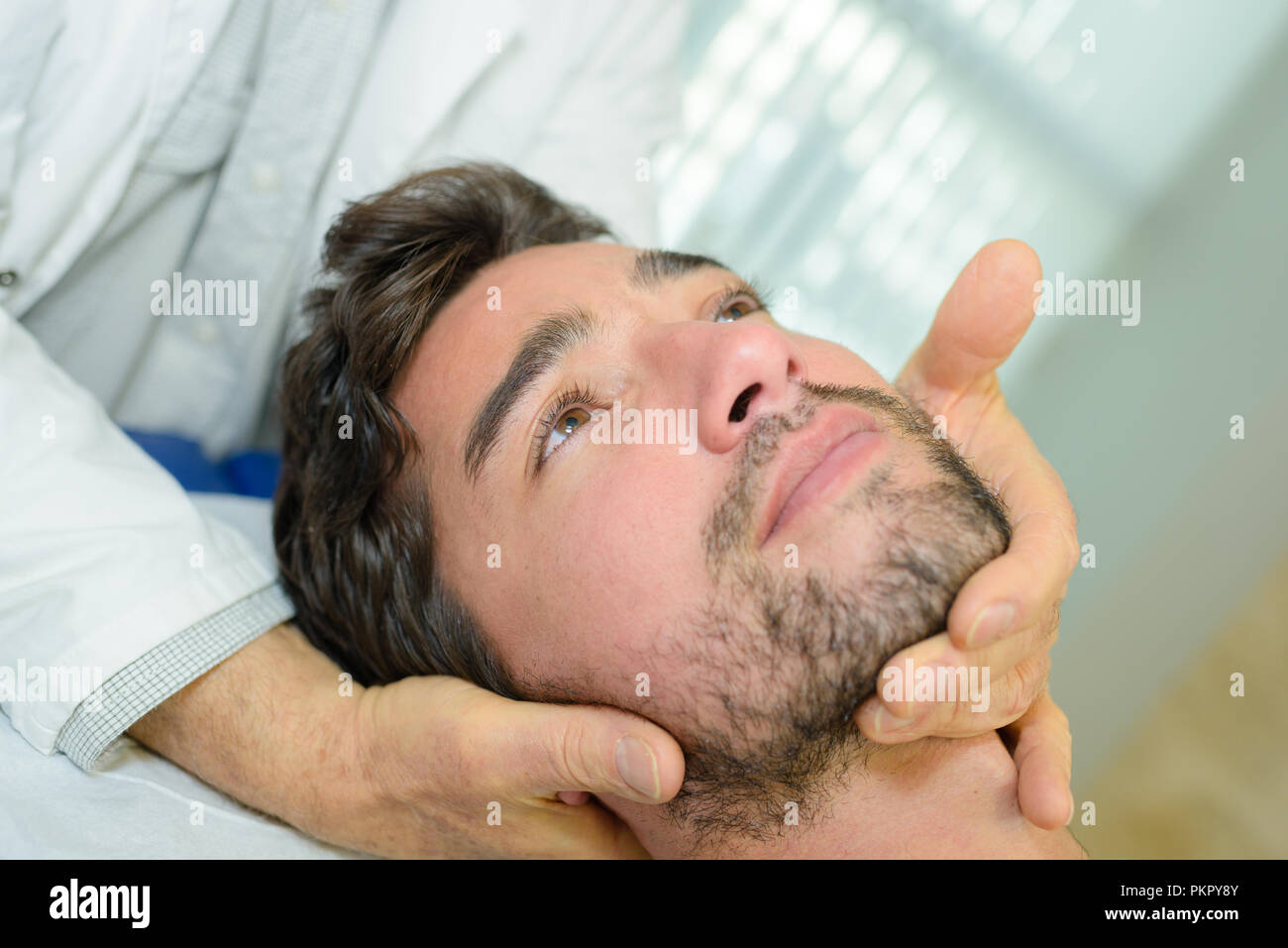 physio therapist giving a head treatment Stock Photo - Alamy