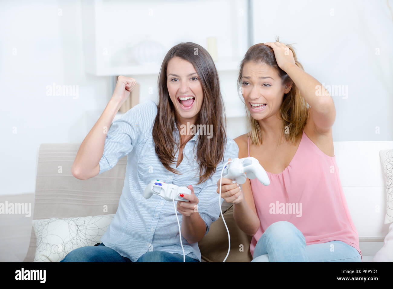 Young ladies playing computer game Stock Photo - Alamy