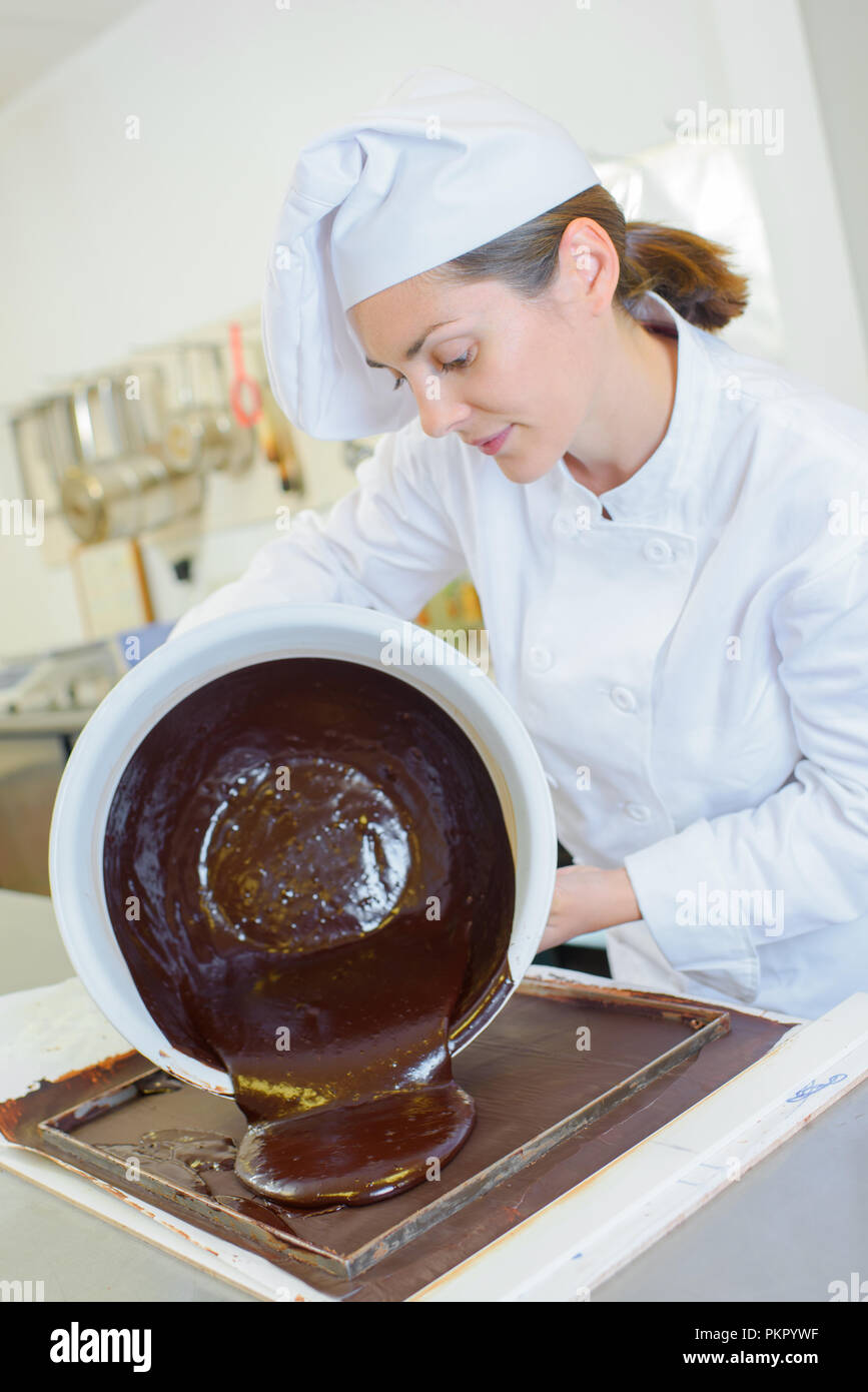Woman pouring chocolate ganache hi-res stock photography and images - Alamy