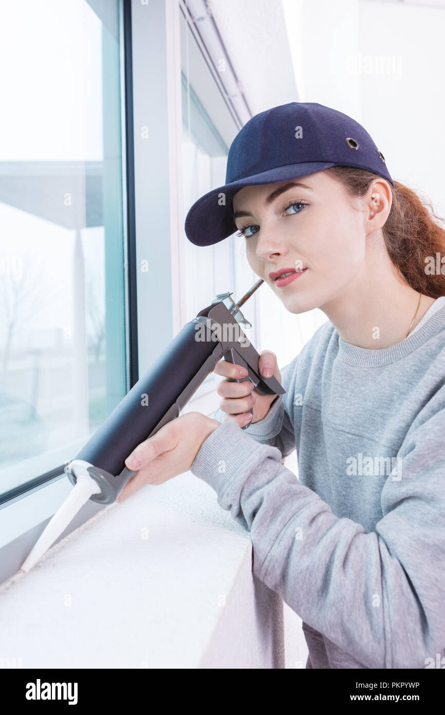 female construction worker installing window in house Stock Photo - Alamy