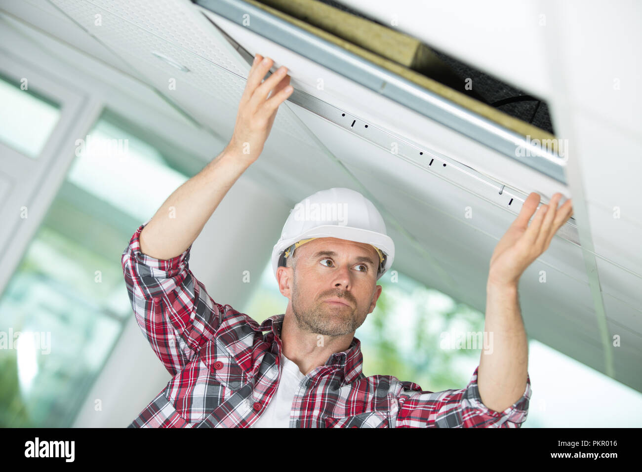 man removing panel on ceiling Stock Photo - Alamy