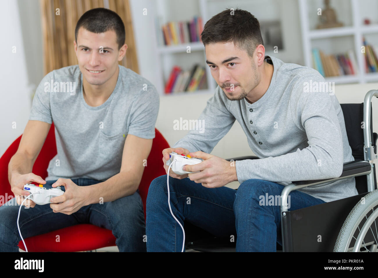 happy young brothers playing video games Stock Photo - Alamy