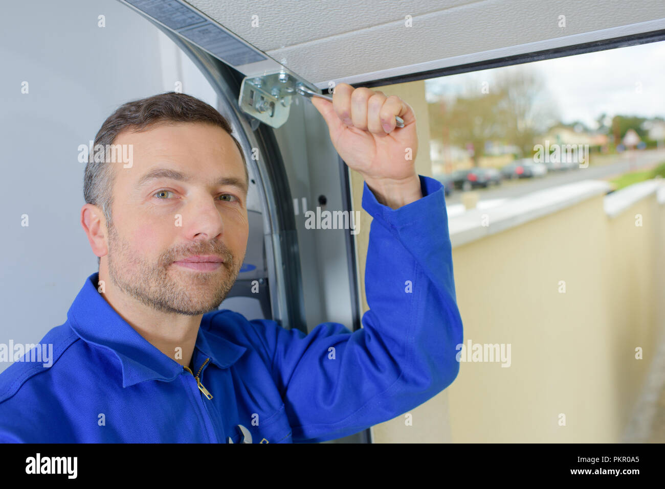 portrait of mechanic fitting bracket with spanner Stock Photo - Alamy