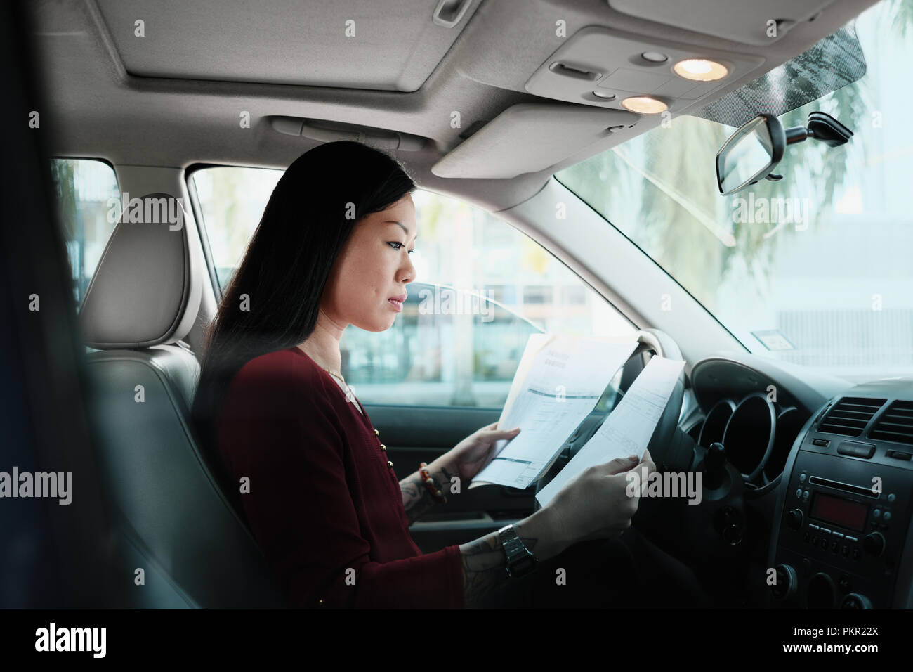Chinese female manager working in car. Successful Asian businesswoman ...