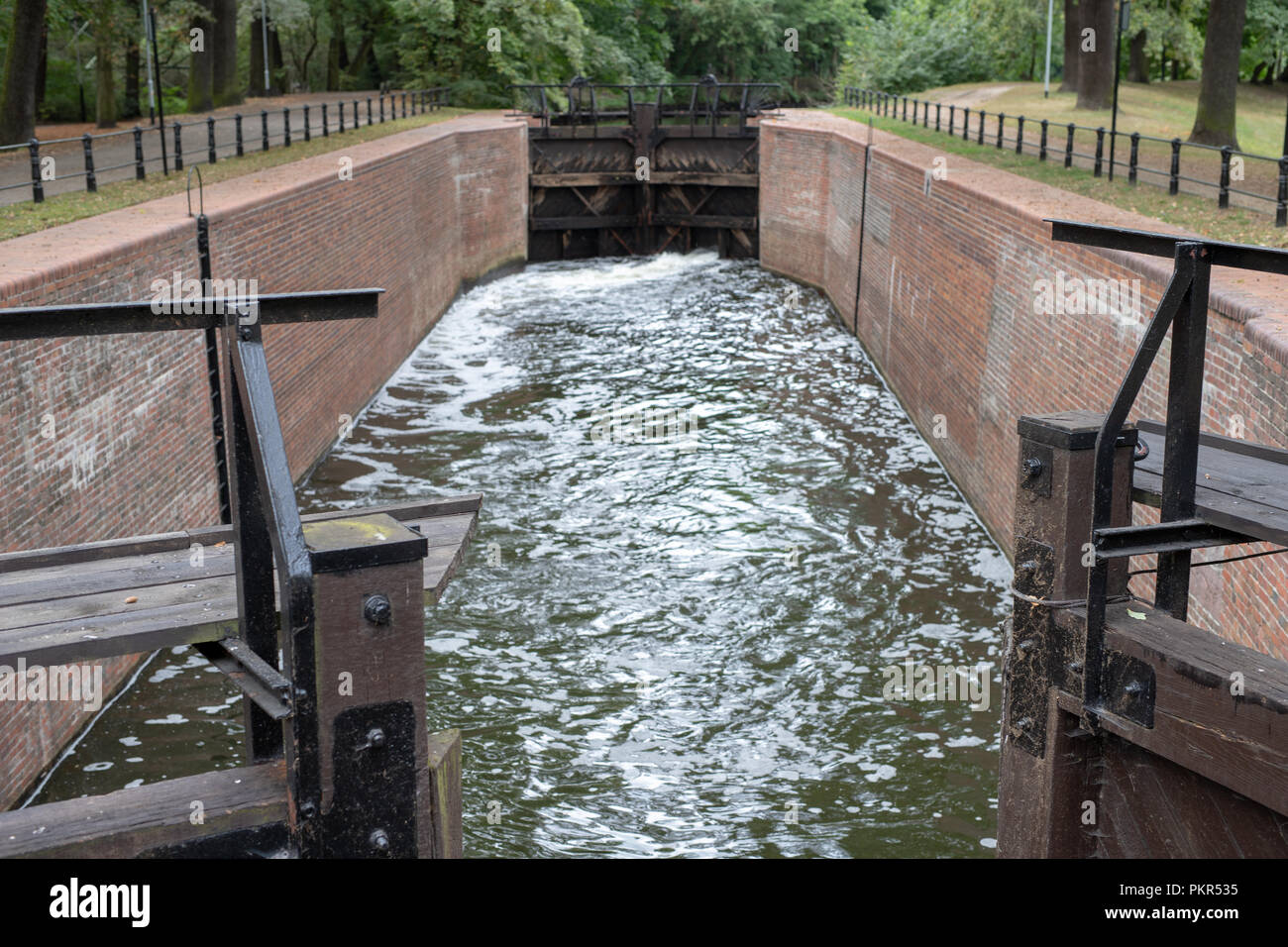 Old sluice on the channel in Central Europe. A wooden dam on the river ...