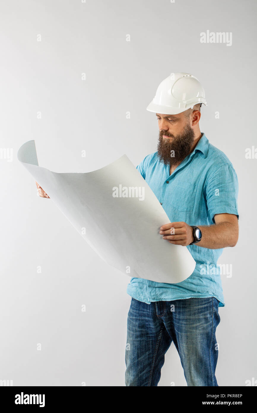 roll paper man reflective vest helmet. foreman or architect considers ...