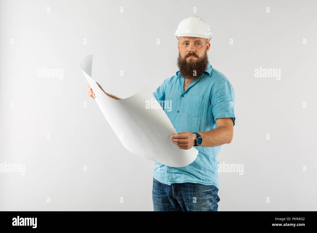 roll paper man reflective vest helmet. foreman or architect considers ...