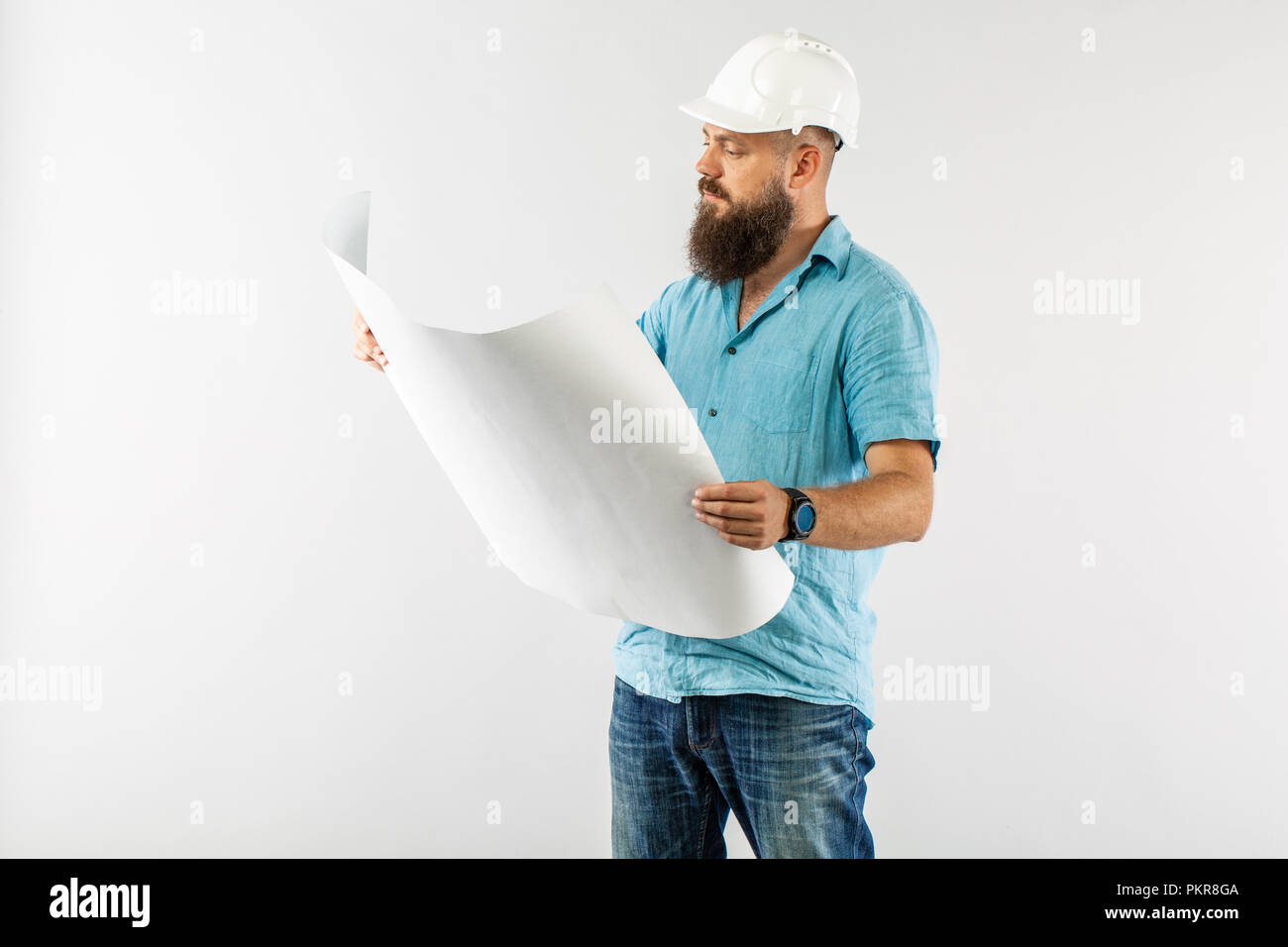 roll paper man reflective vest helmet. foreman or architect considers ...