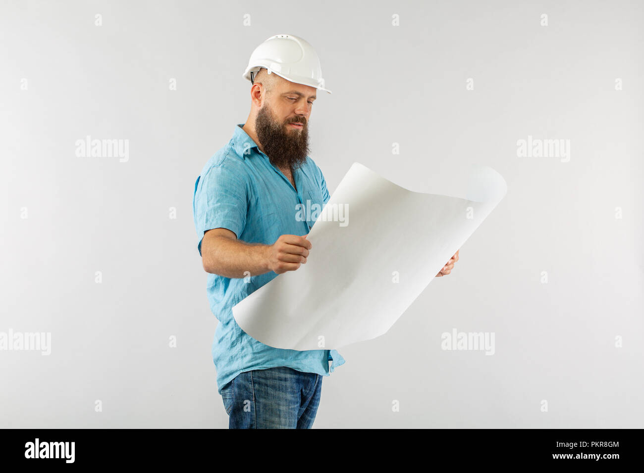 roll paper man reflective vest helmet. foreman or architect considers ...