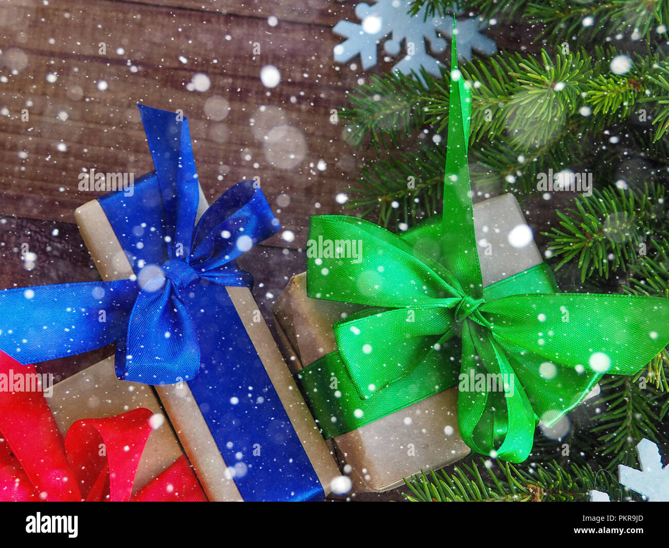 Christmas gift box with red ribbon on wooden background, many Christmas ...