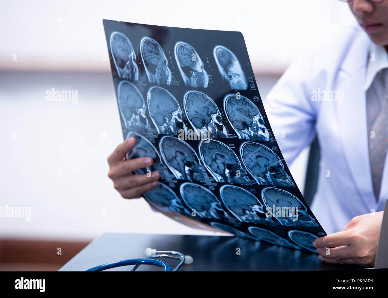 young female doctor holding MRI or CT scan picture, doctor in uniform ...