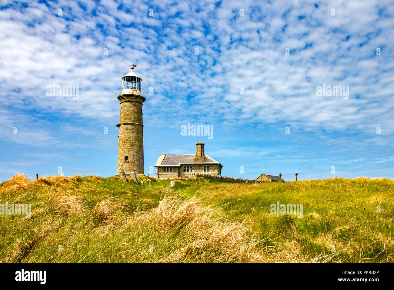 The Old Light lighthouse on Lundy Island seen across the fields Stock ...
