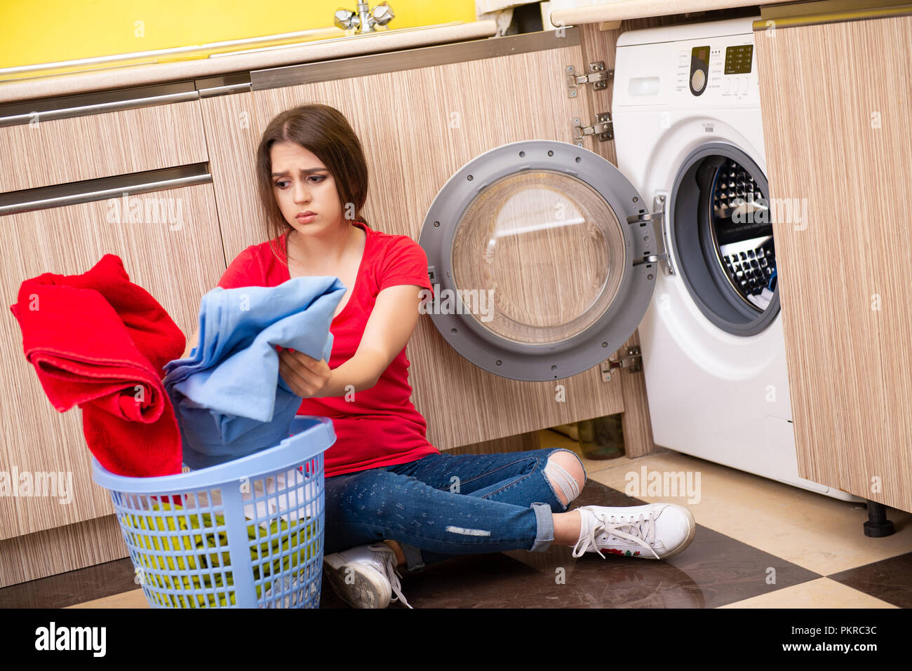Woman doing laundry at home Stock Photo - Alamy