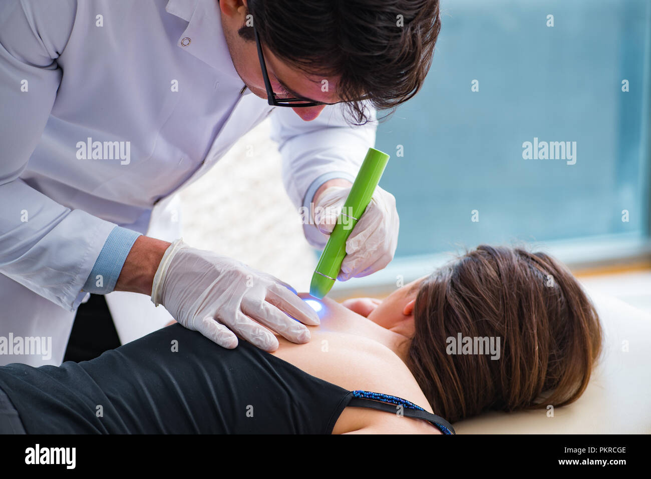 Patient in clinic undergoing laser scar removal Stock Photo - Alamy