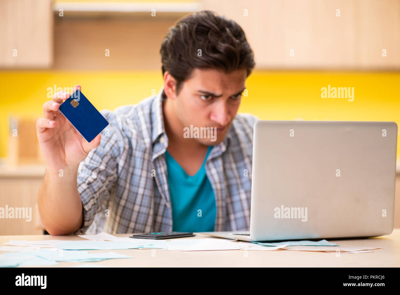 Young man husband in budget planning concept Stock Photo - Alamy