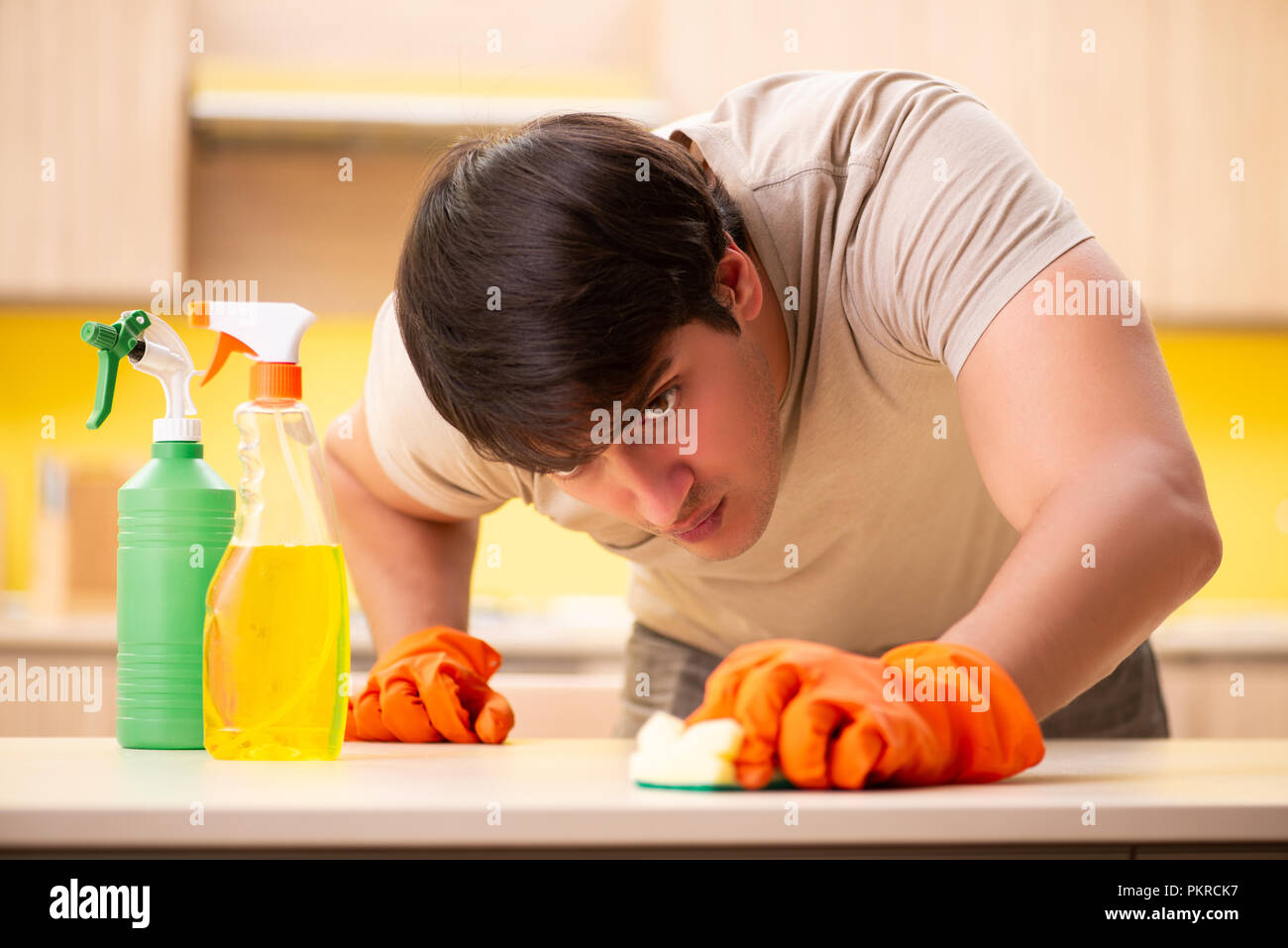 Single man cleaning kitchen at home Stock Photo - Alamy