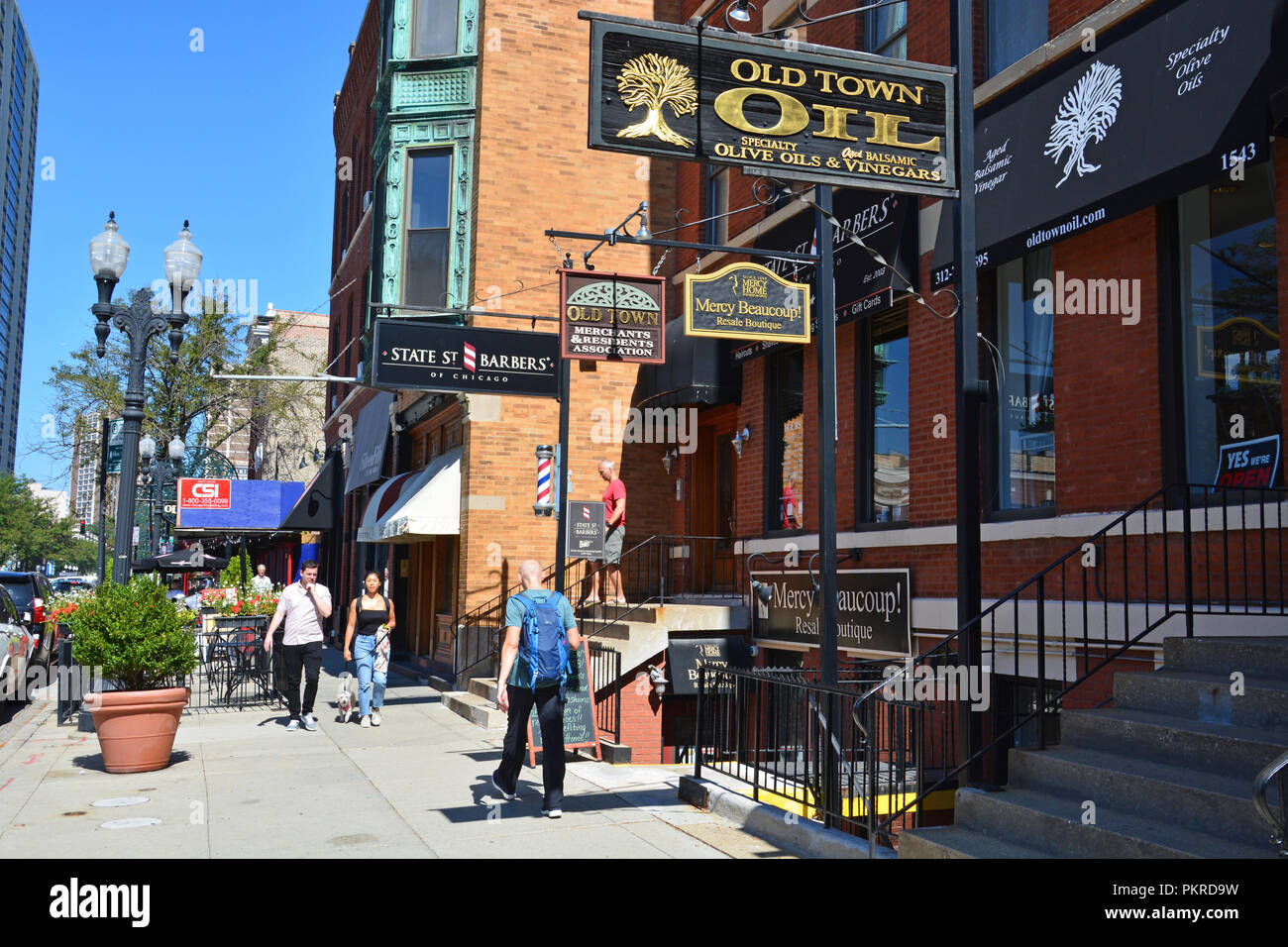 Residents walk past small businesses that line the the Old Town ...