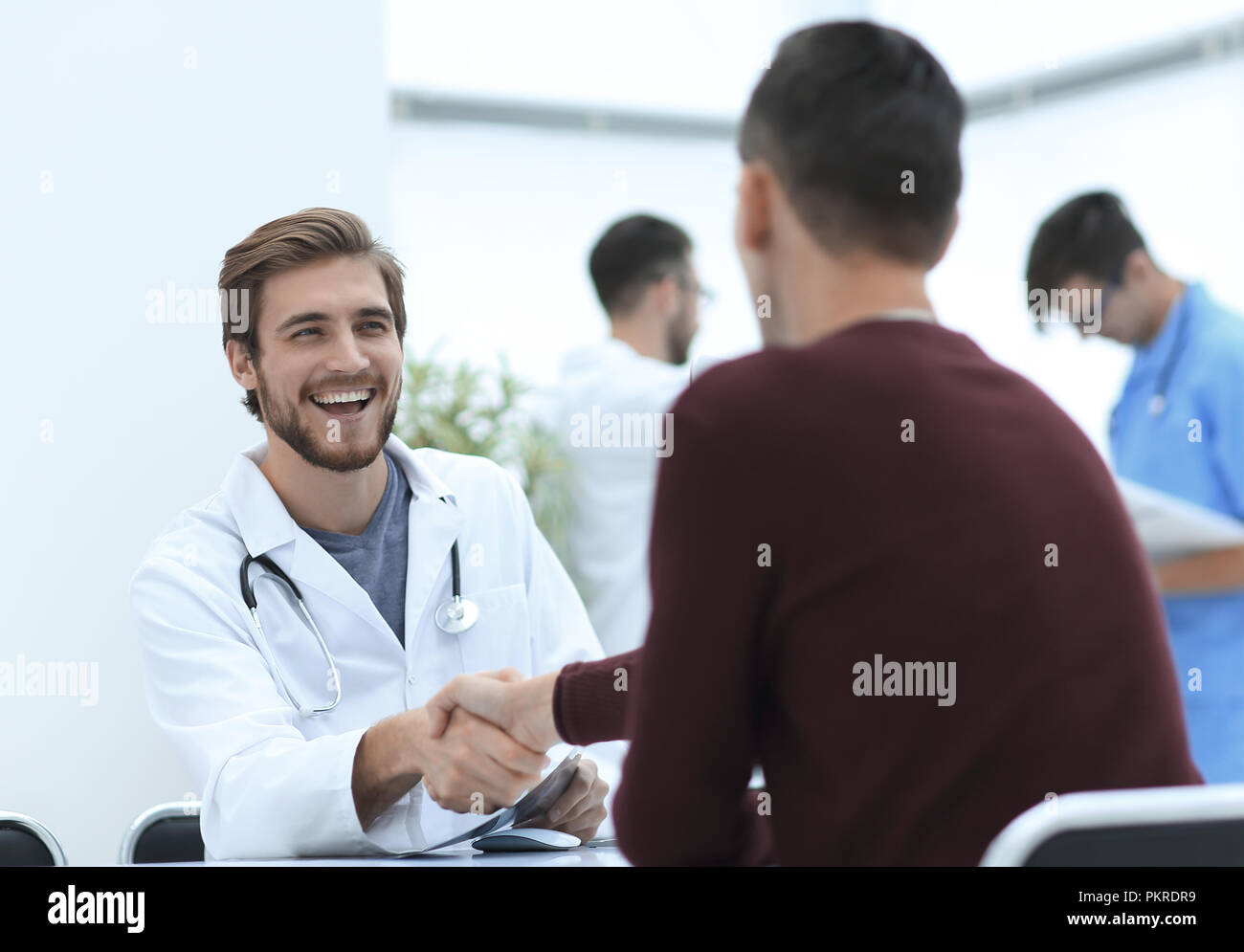 Doctor giving handshake patient hi-res stock photography and images - Alamy