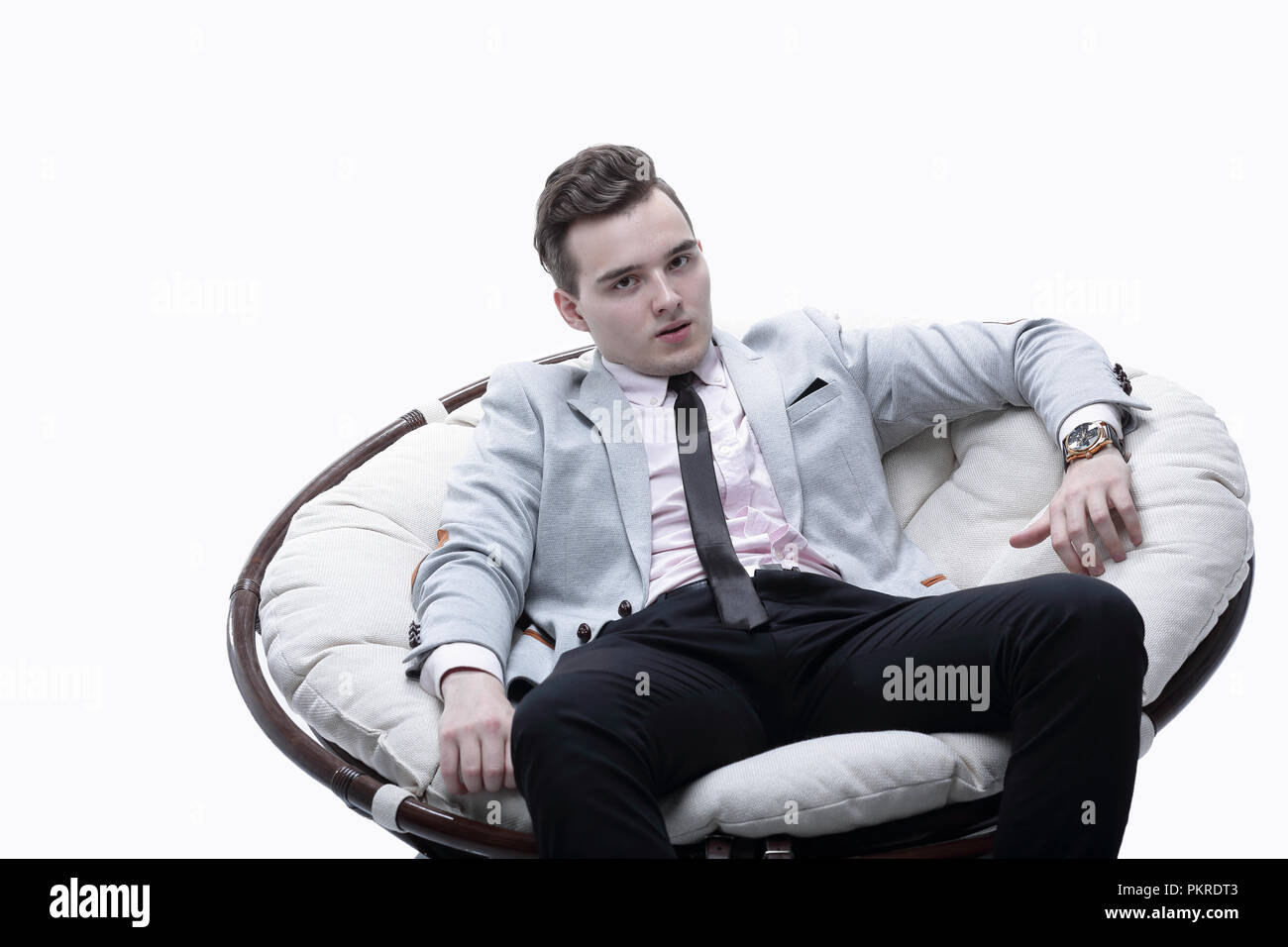 tired businessman sitting in a round chair made of rattan Stock Photo ...