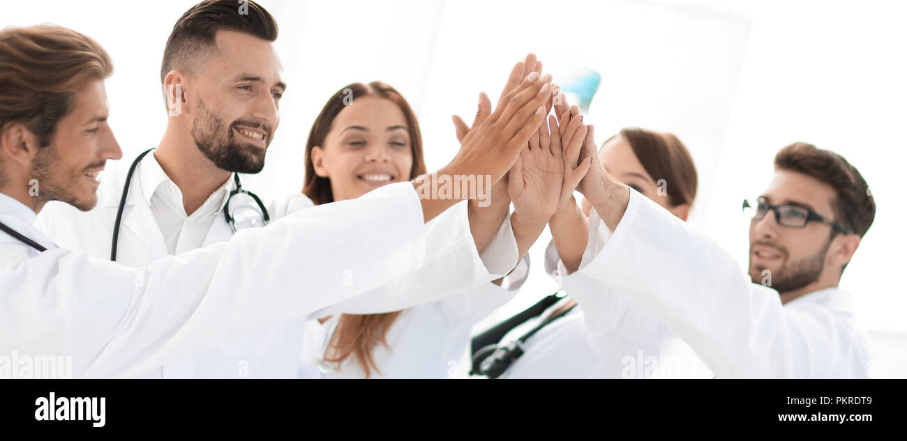 group of doctors giving each other a high five Stock Photo - Alamy