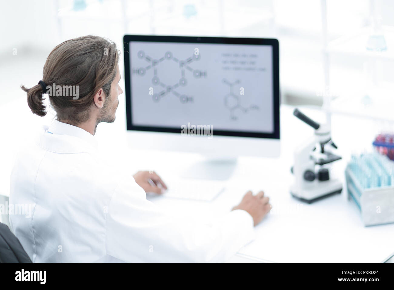 Young man working in a medical lab using a computer Stock Photo - Alamy