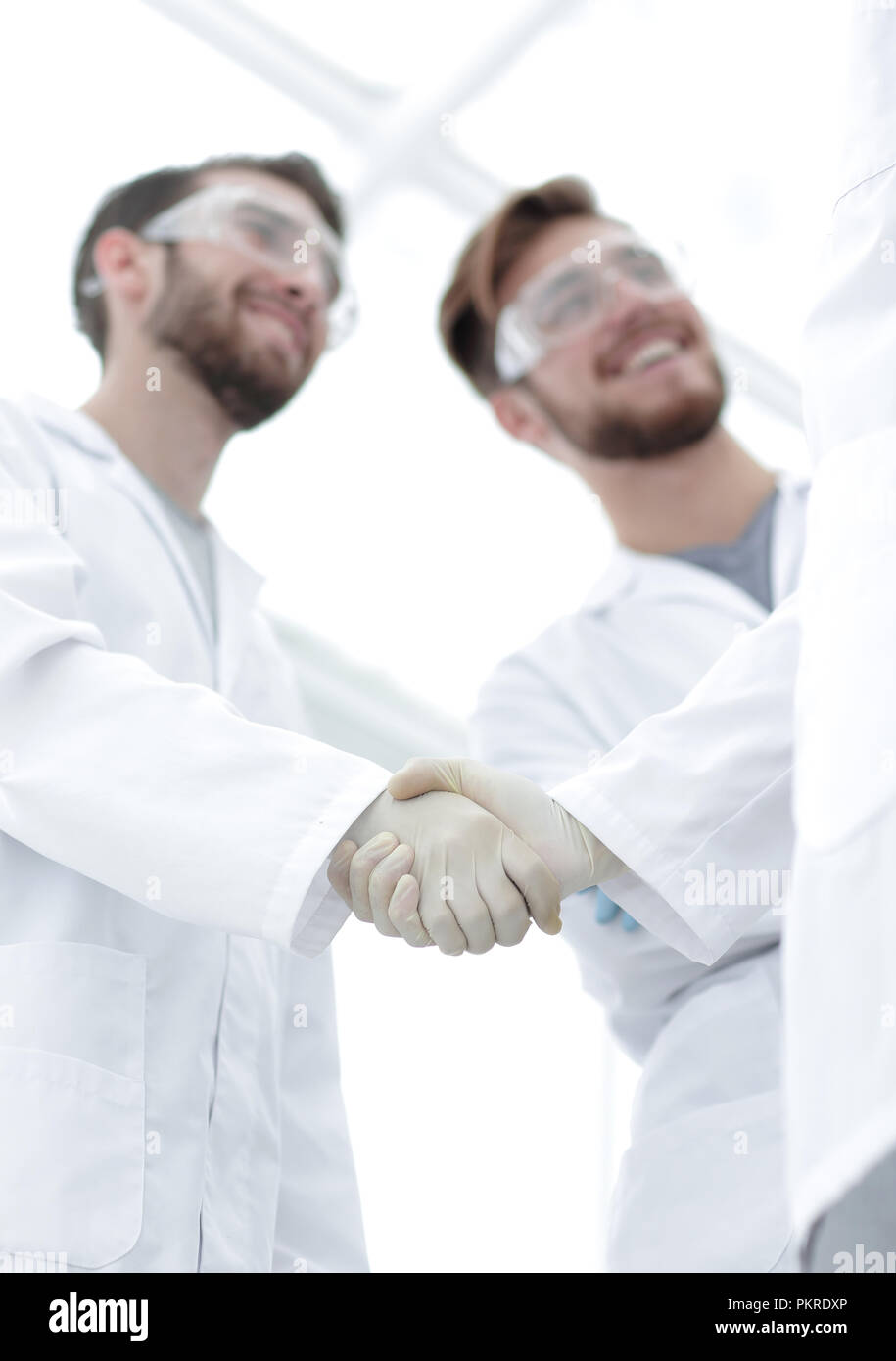 blurred image of a handshake between scientists Stock Photo - Alamy