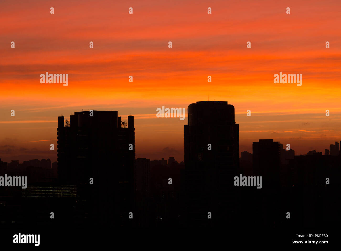 Sunrise between buildings Stock Photo - Alamy