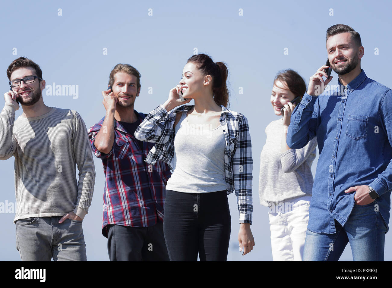 group of students talking on their smartphones Stock Photo - Alamy