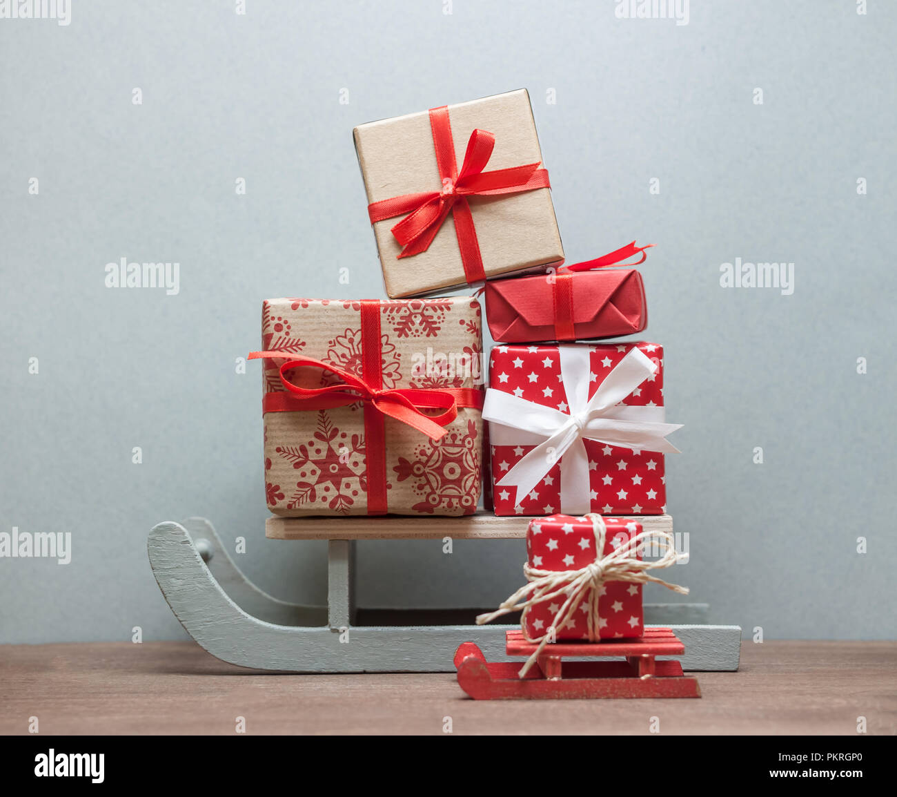christmas sledges with pile of presents blue background Stock Photo - Alamy