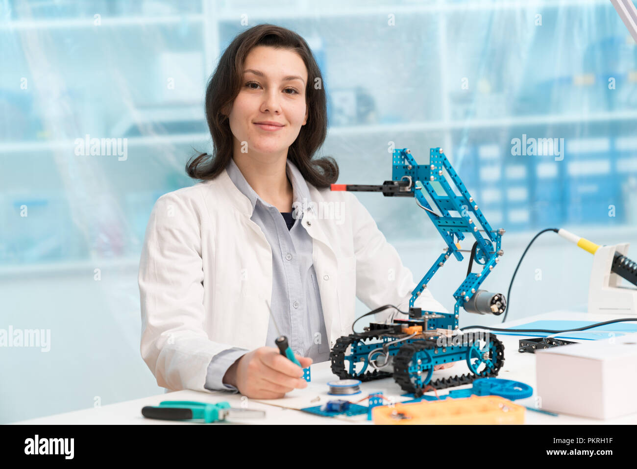 Student girl in electronics laboratory, experiment with microcontroller ...