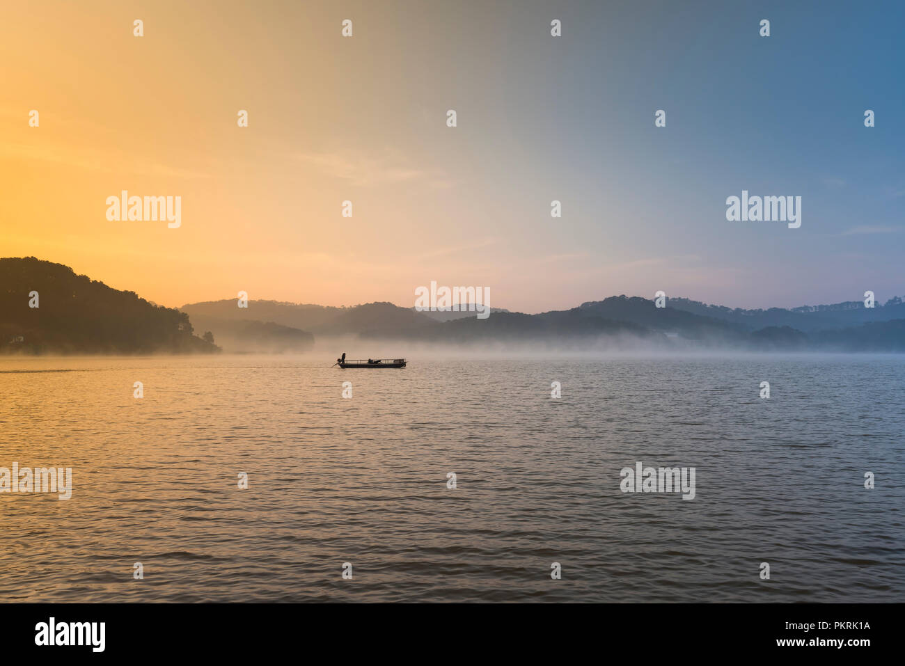Da Lat fisherman wooden boat catching freshwater fish in a natural lake ...