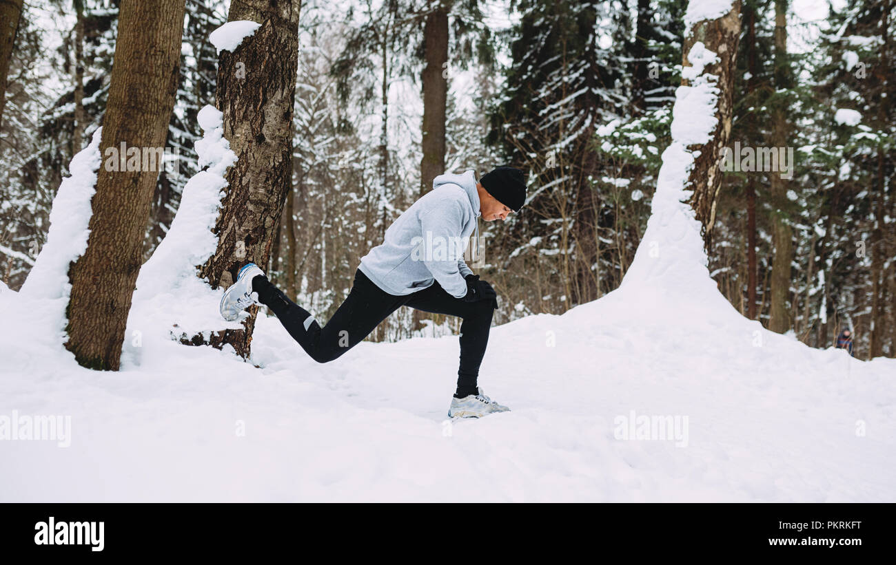 Runner doing stretching exercises hi-res stock photography and images ...