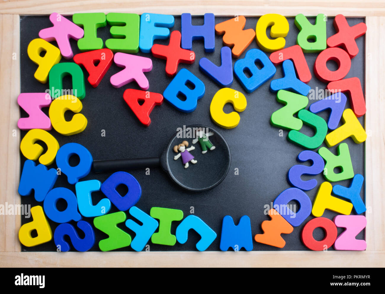 Kids over Magnifying glass and Colorful Letters of Alphabet Stock Photo ...