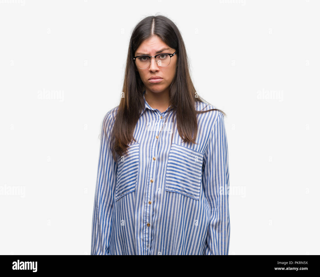 Young beautiful hispanic business woman skeptic and nervous, frowning ...