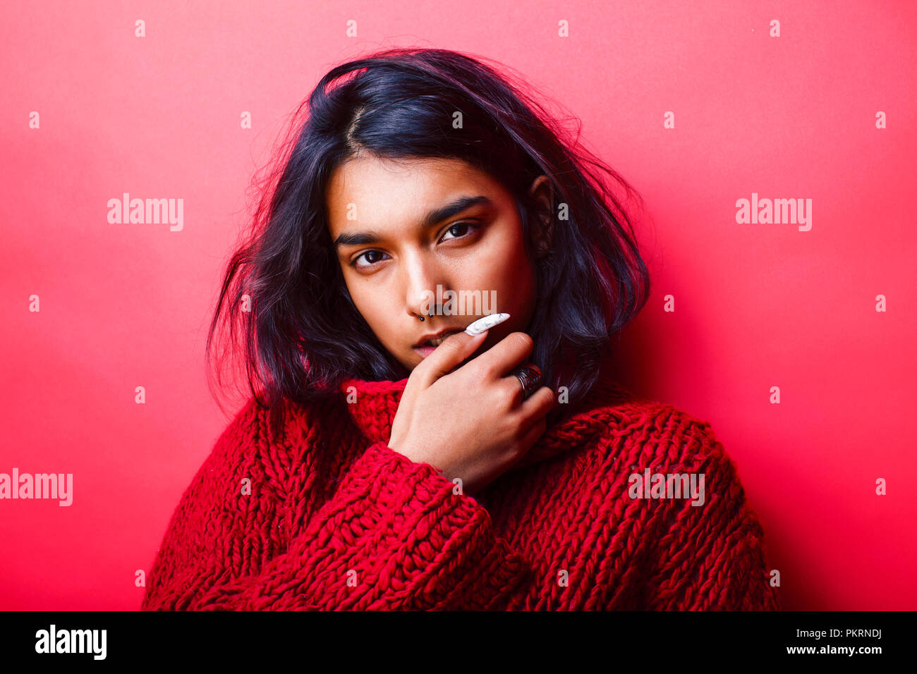young pretty indian mulatto girl in red sweater posing emotional Stock ...