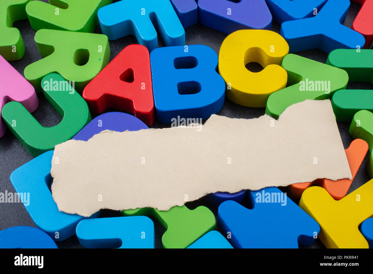 Torn paper placed on Colorful Letters of Alphabet Stock Photo - Alamy