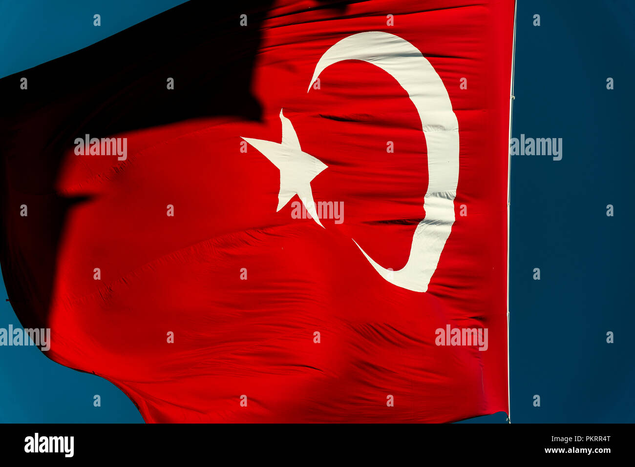 Turkish flag hanging on a blue background Stock Photo - Alamy