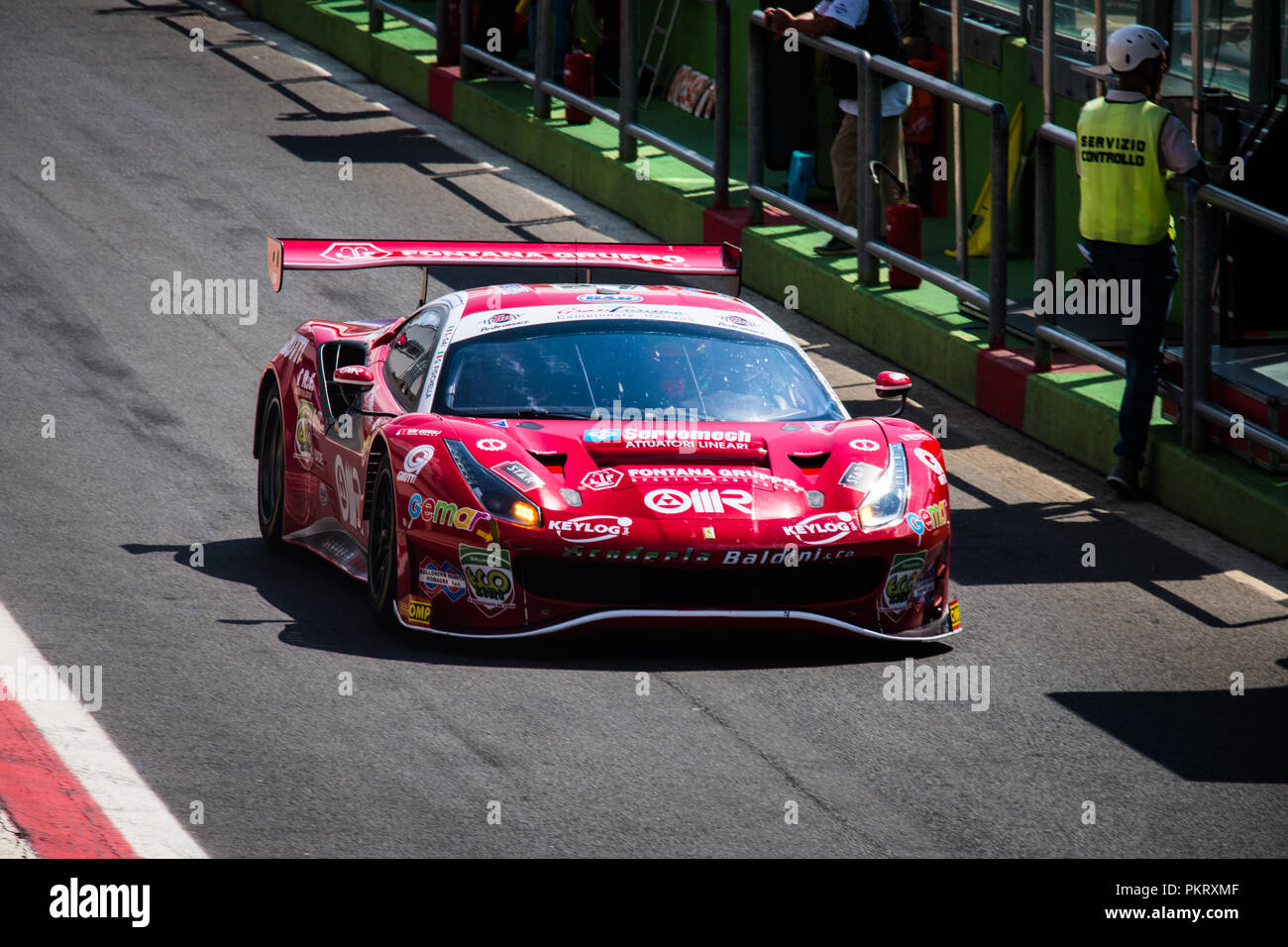 High angle view full length of Ferrari touring car in racing circuit ...
