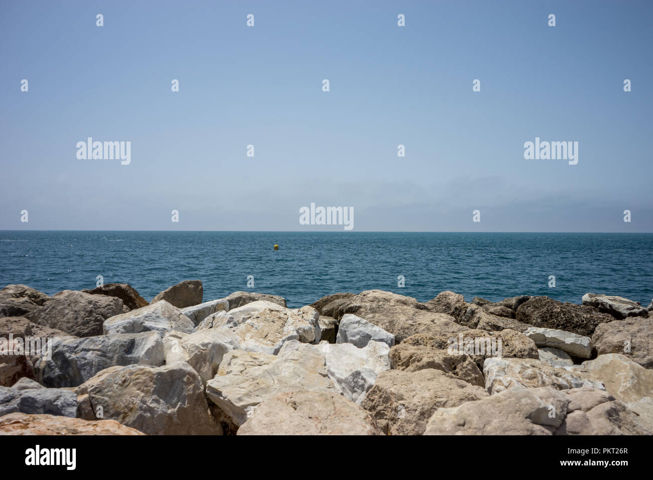 Rocks against the green ocean at Malagueta beach in malaga, Spain ...