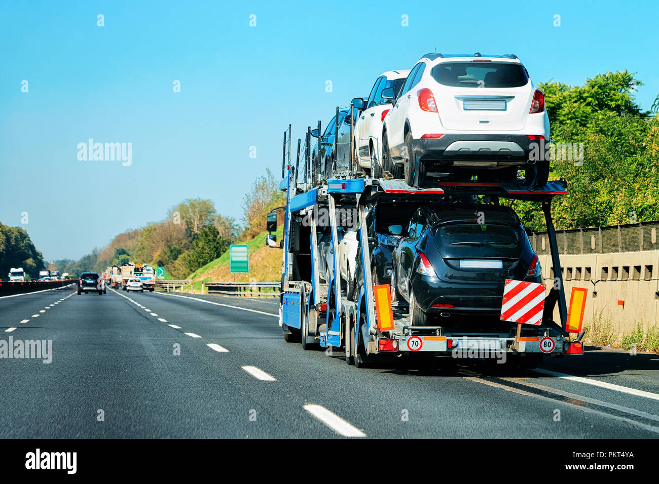 New car carrier in the road. Truck transporter Stock Photo - Alamy