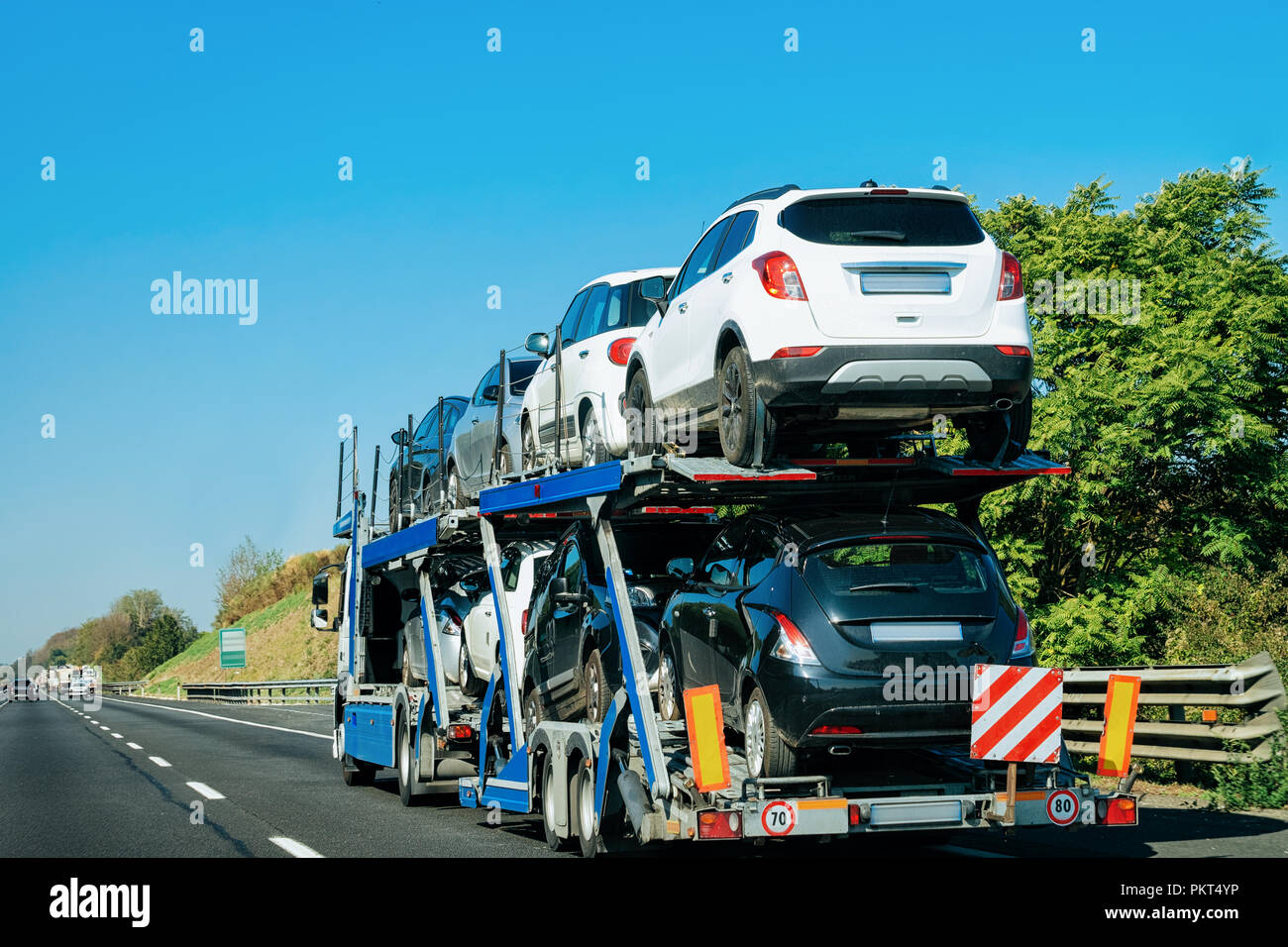 New car carrier on the road. Truck transporter Stock Photo - Alamy