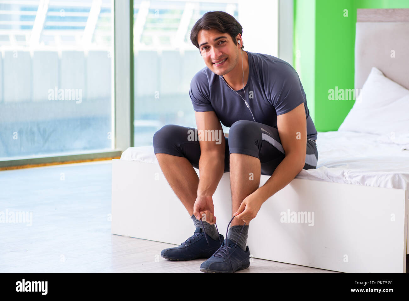 Young handsome man doing morning exercises in the hotel room Stock ...
