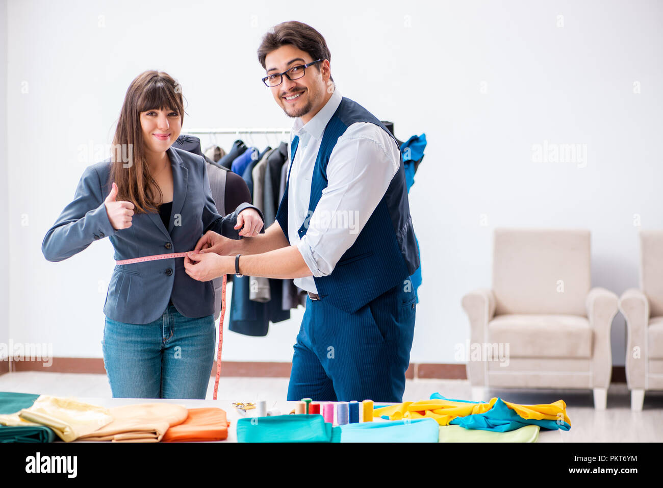 Professional tailor taking measurements for formal suit Stock Photo - Alamy