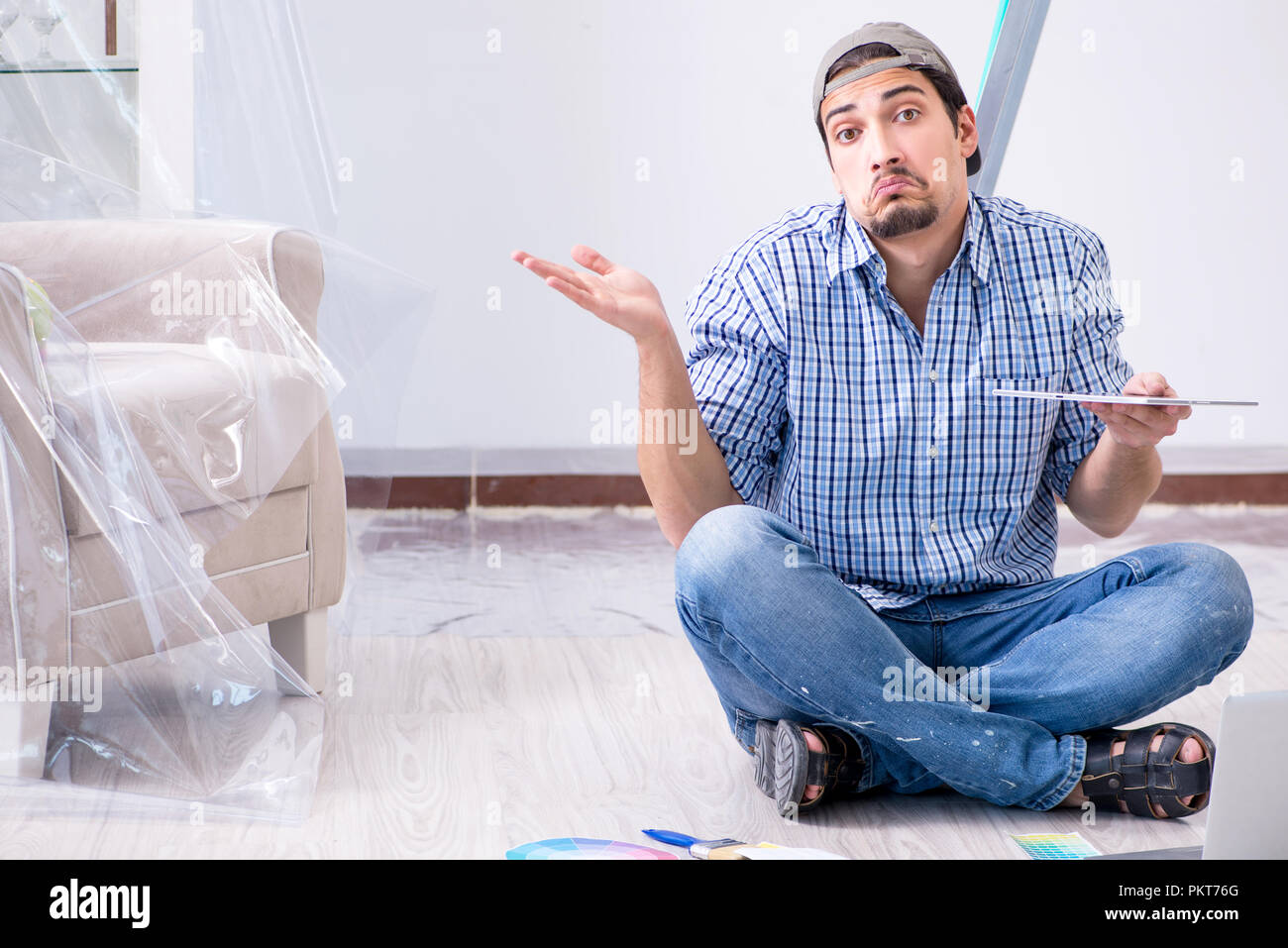 Young man contractor choosing color from rainbow Stock Photo - Alamy