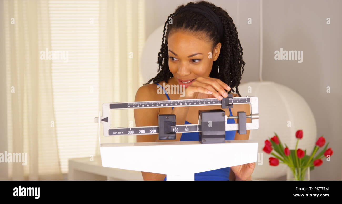 Cute black woman dancing on scales Stock Photo - Alamy