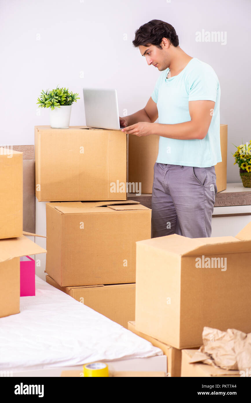 Young man moving to new apartment Stock Photo - Alamy