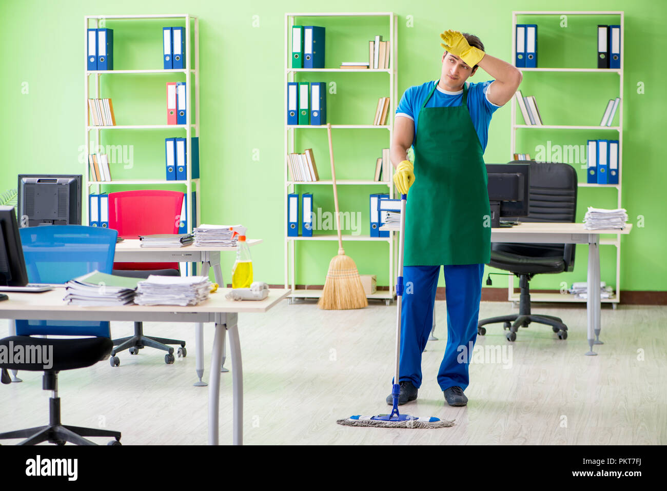 Male handsome professional cleaner doing mopping in the office Stock ...
