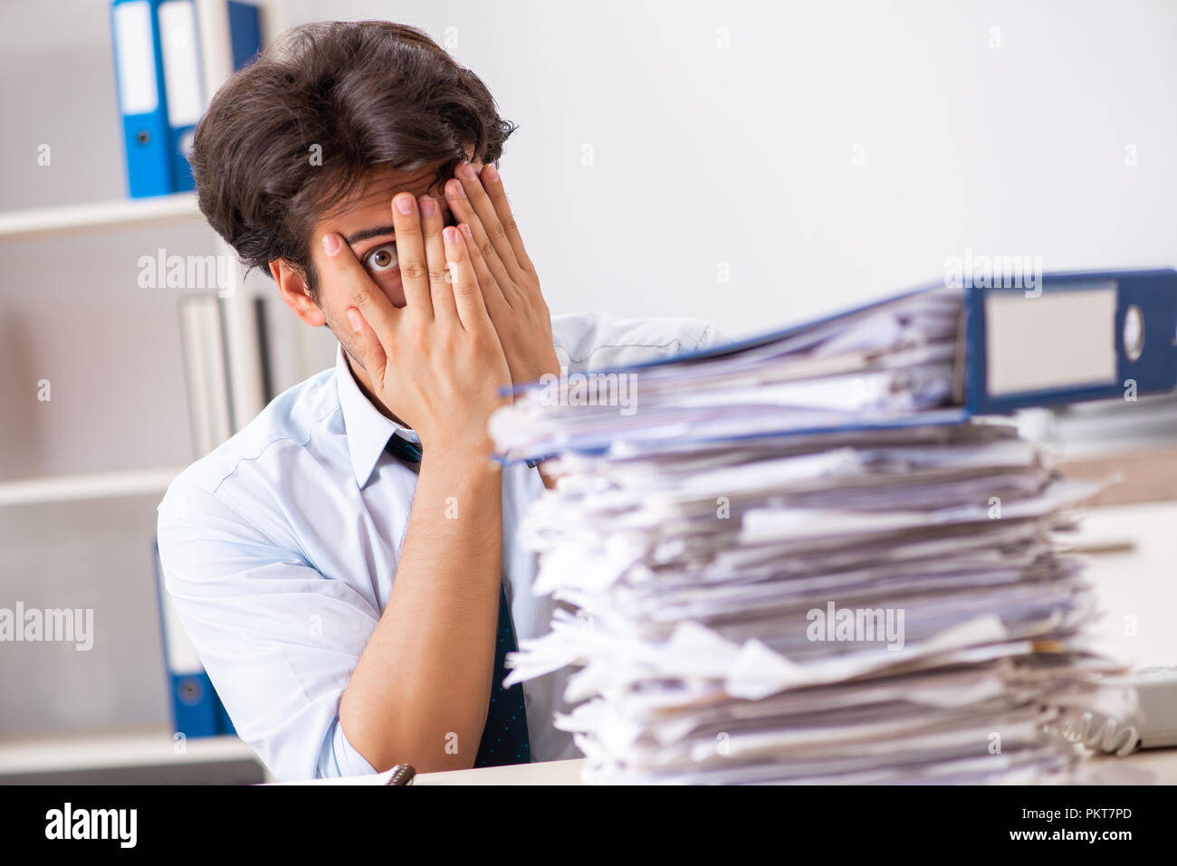 Overloaded busy employee with too much work and paperwork Stock Photo ...