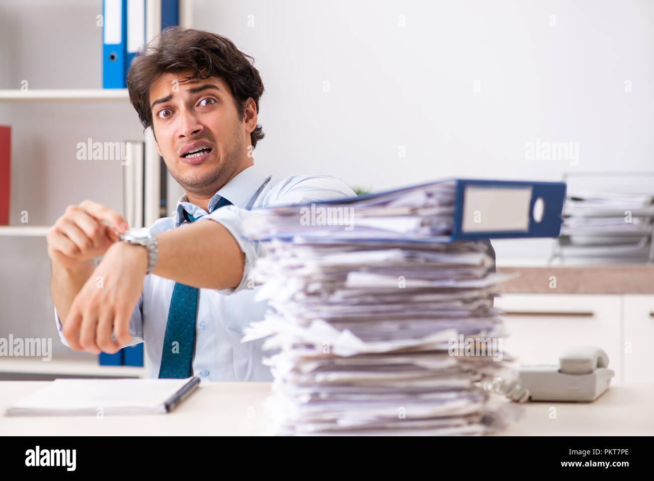Overloaded busy employee with too much work and paperwork Stock Photo ...