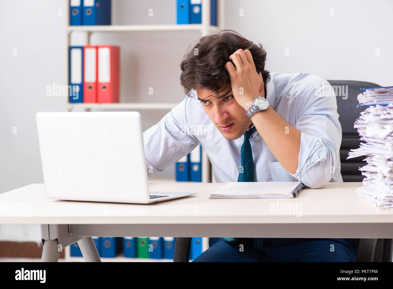 Overloaded busy employee with too much work and paperwork Stock Photo ...